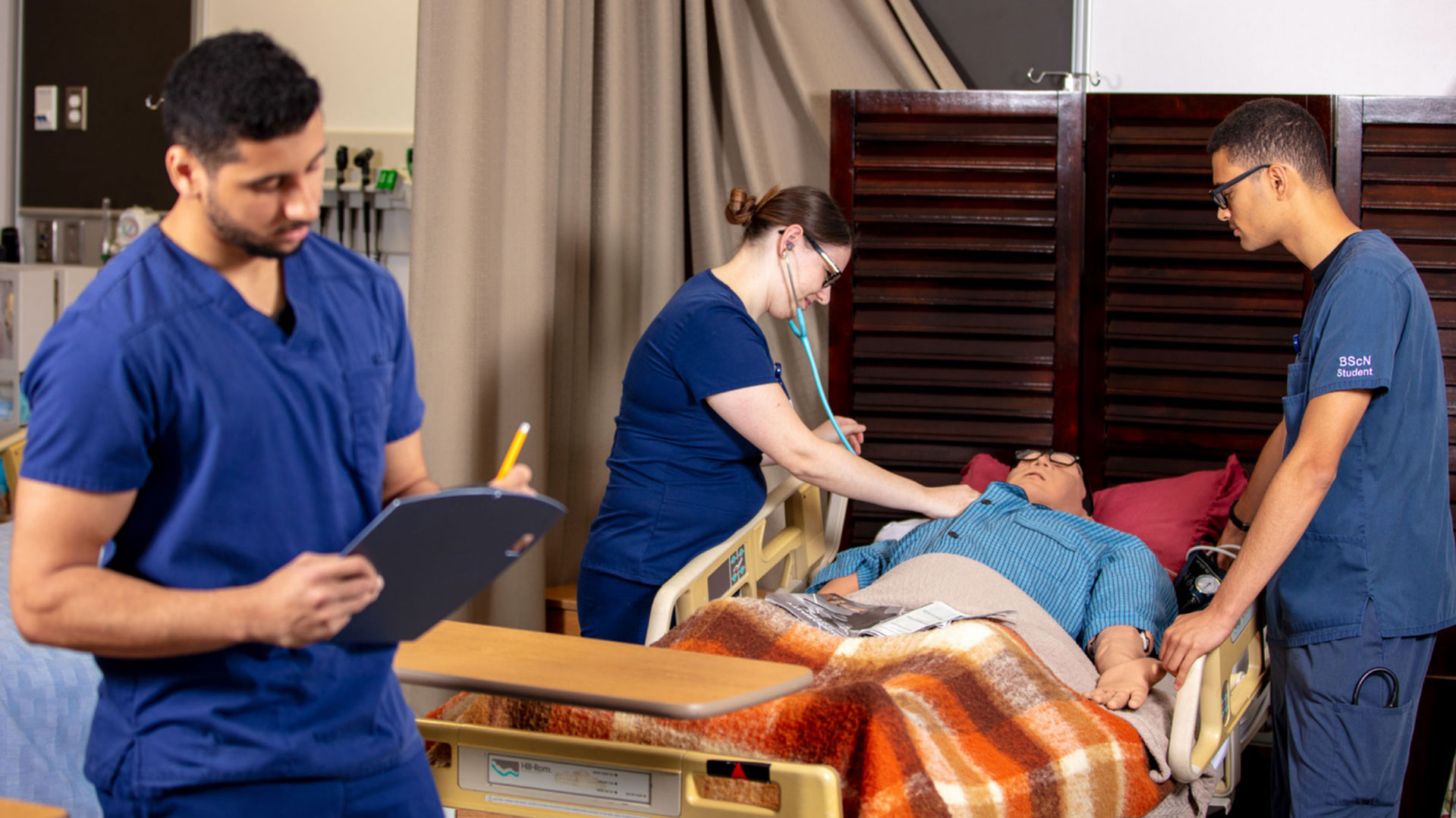 Nursing students working together in lab