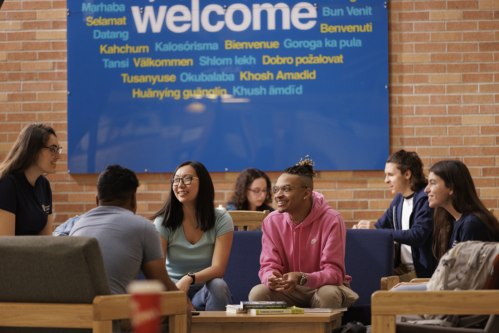 Students talking in front of welcome sign